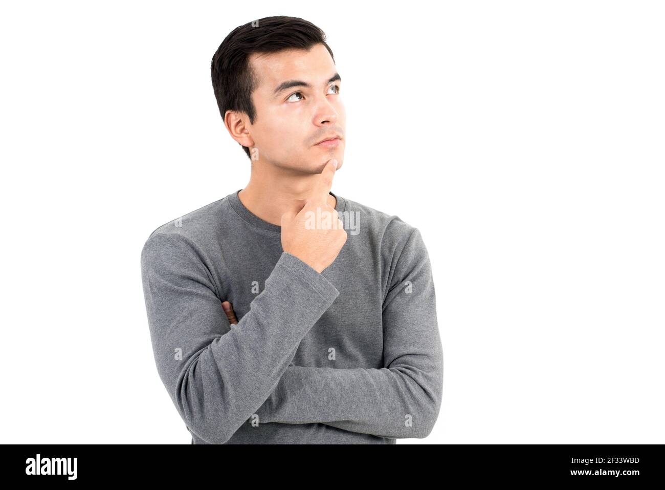 Thoughtful man with eyes looking up - isolated on white background ...