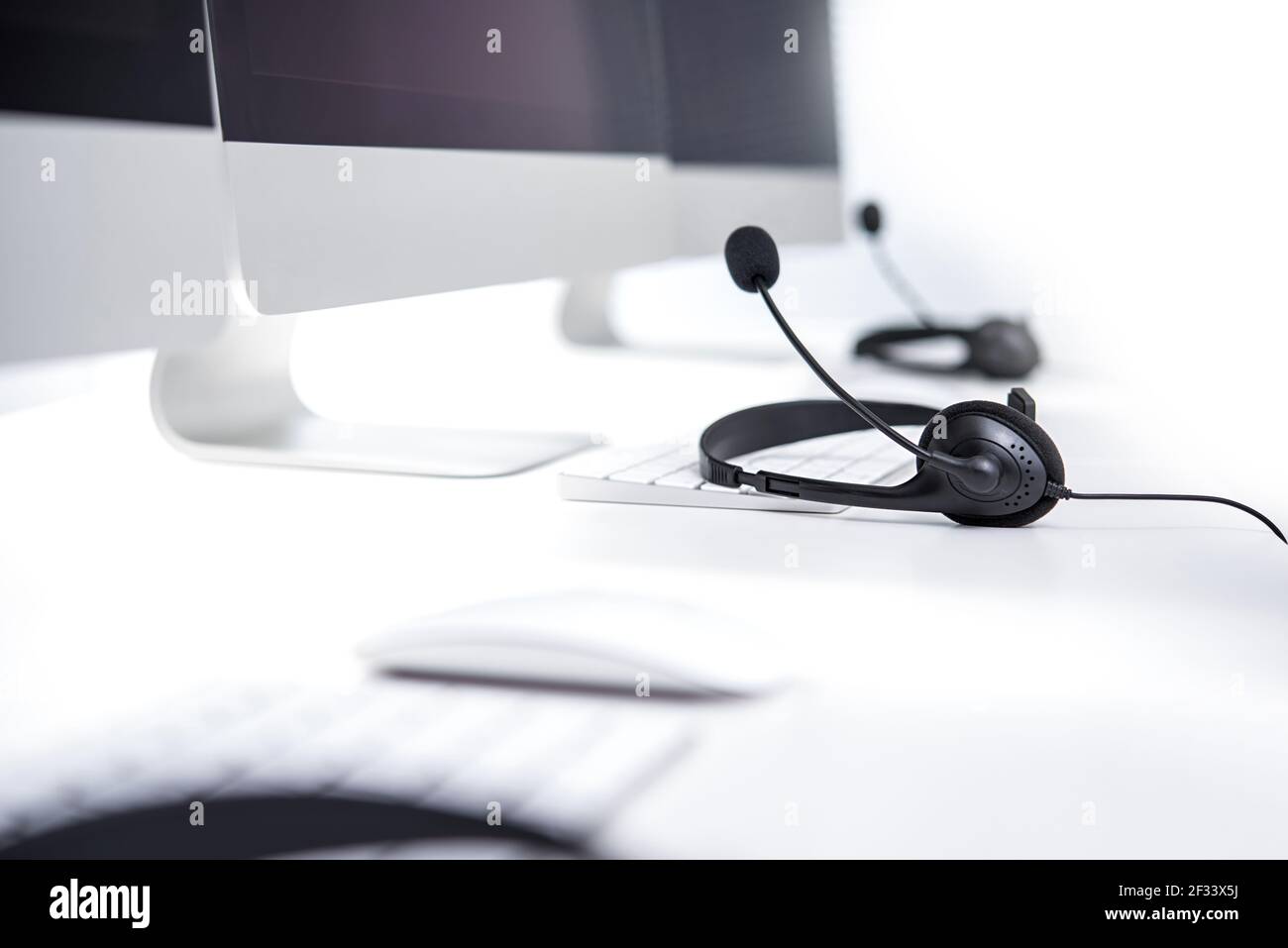 Microphone headsets on the table with computer keyboard - call center ...
