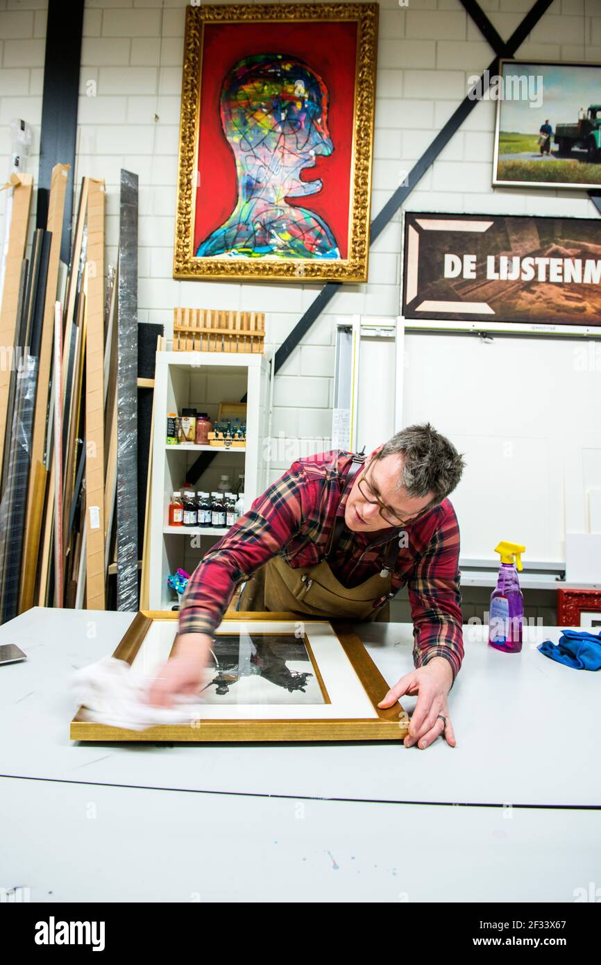Goirle, Netherlands. Mid adult male craftsman and picture framemaker ...