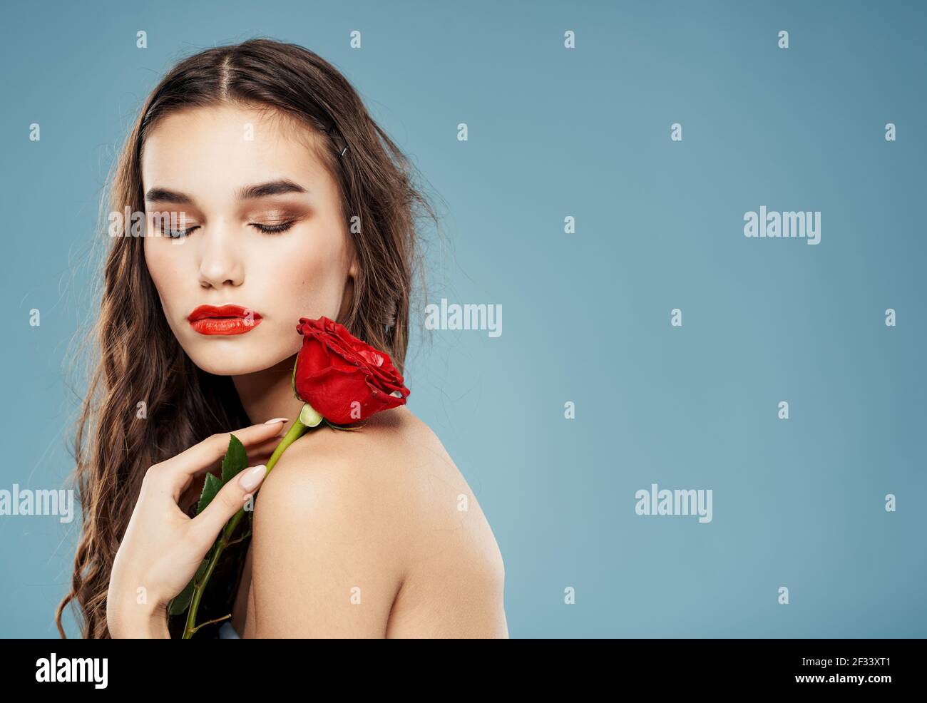 Romantic people with a red rose in their hands on a blue background ...