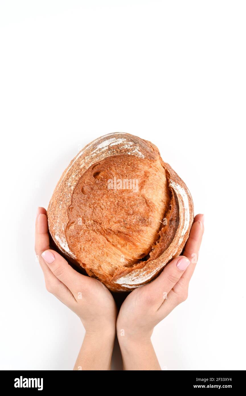 Round homemade bread in hands, on an isolated background . High quality ...