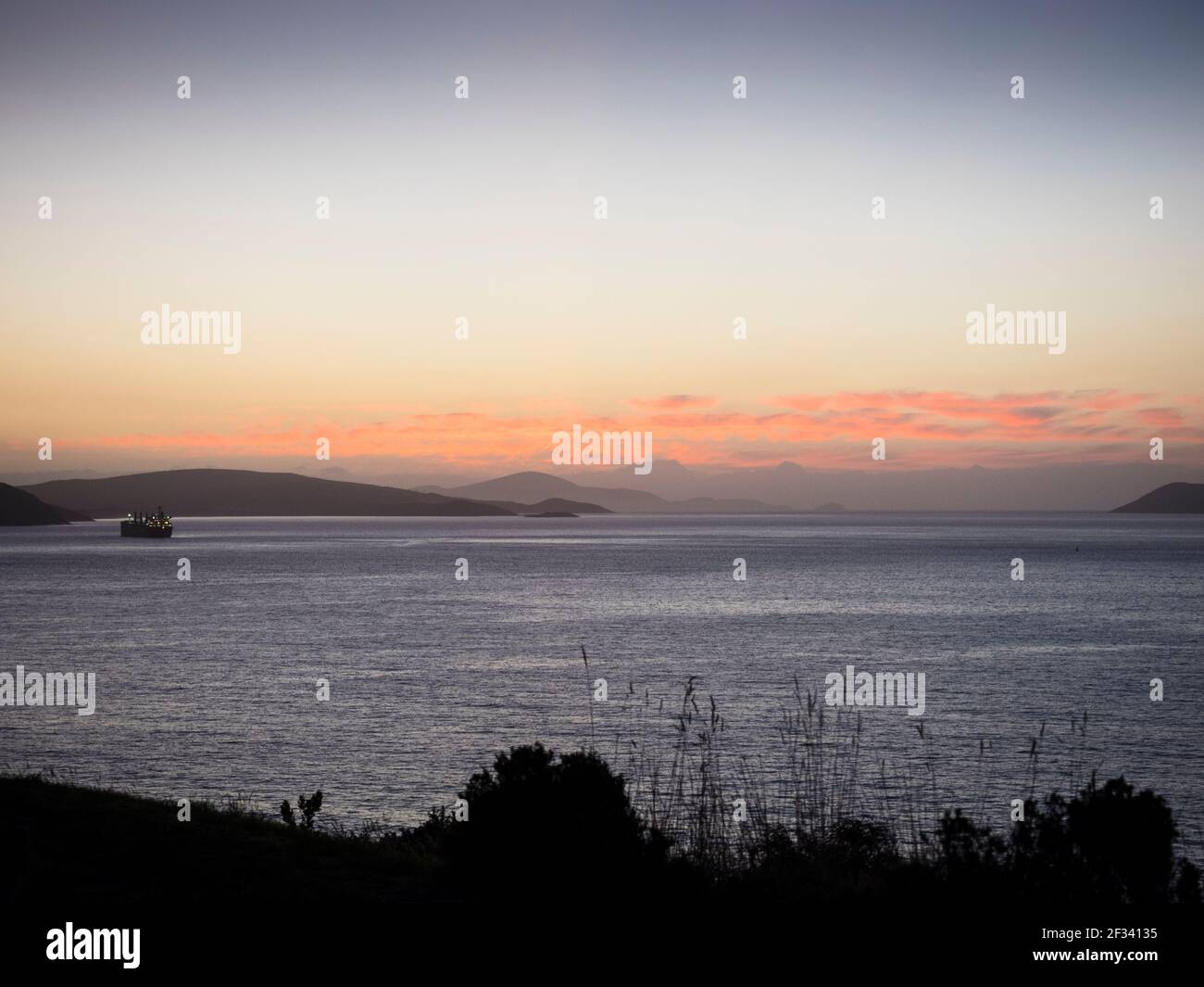 Coastal freighter at anchor at sunrise, Frenchman Bay, Southern Ocean ...