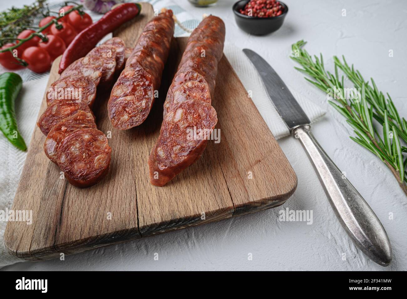 Traditional chorizo cuts with spices and ingredients on white textured ...