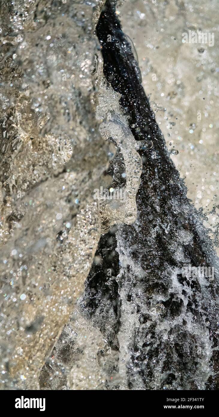 Water backgrounds with foam spray fast flow.The log is stuck in ...