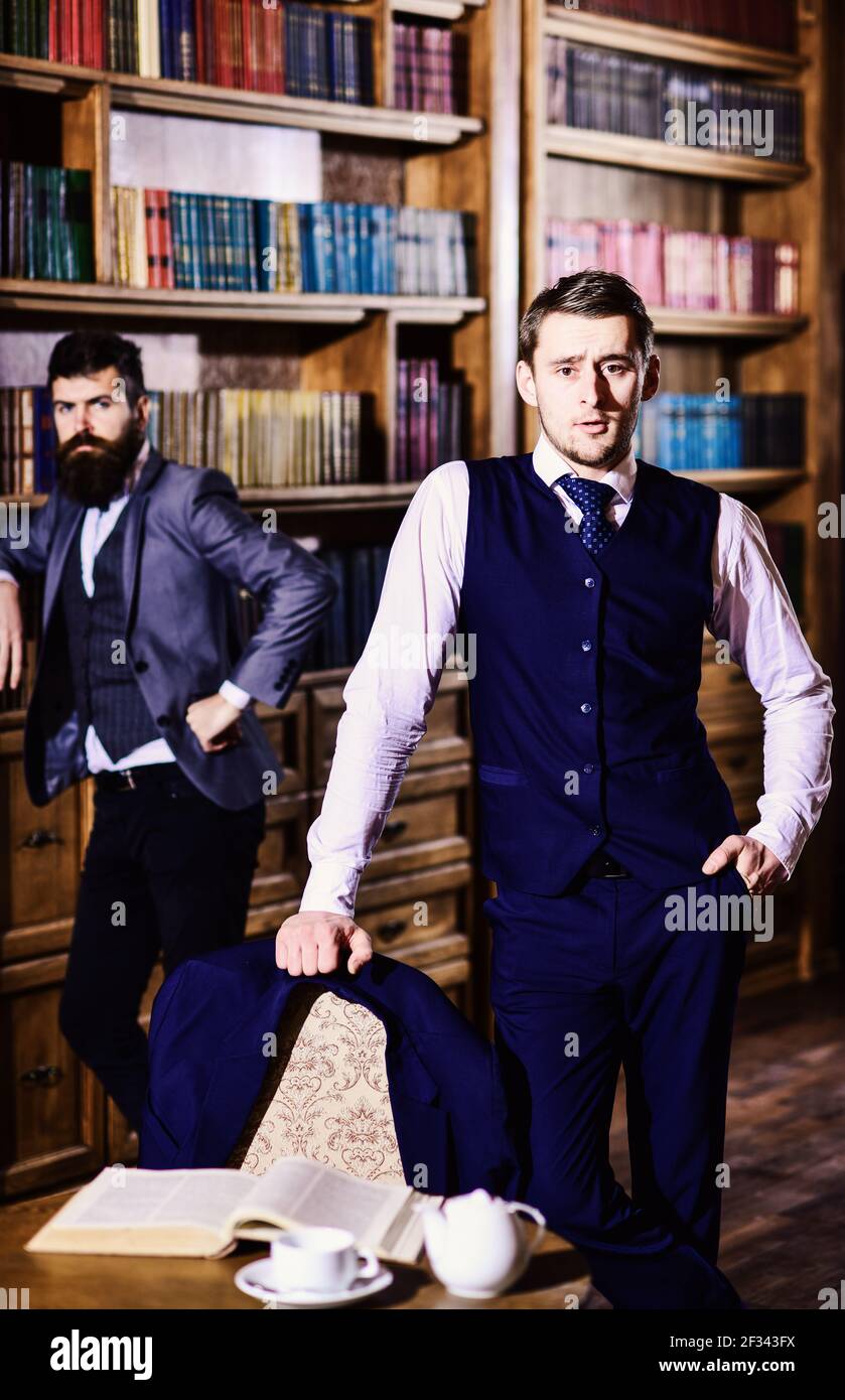 Men in suit, detectives spend leisure in library Stock Photo - Alamy