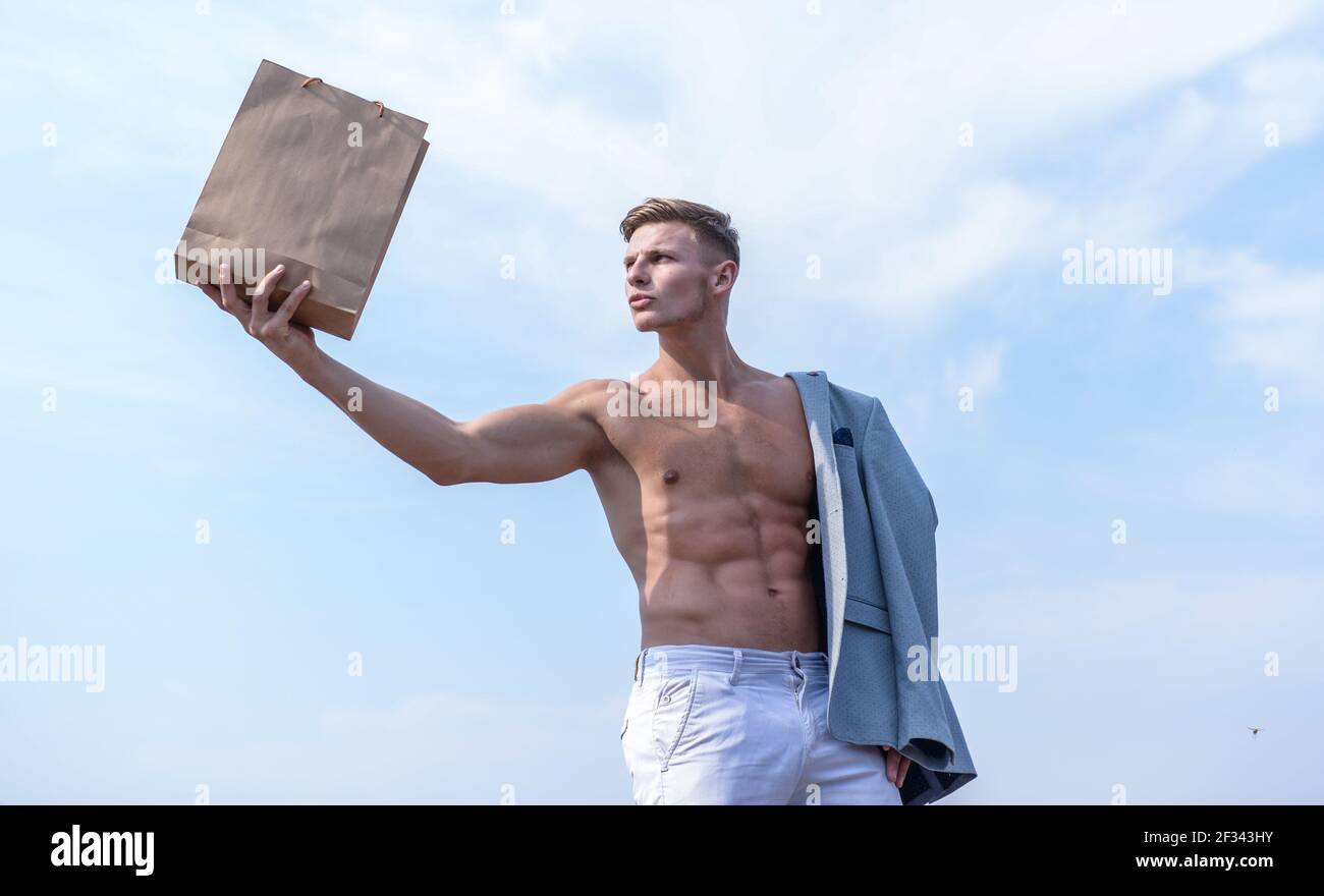 Guy attractive macho carry shopping bag made out of brown paper. Eco ...