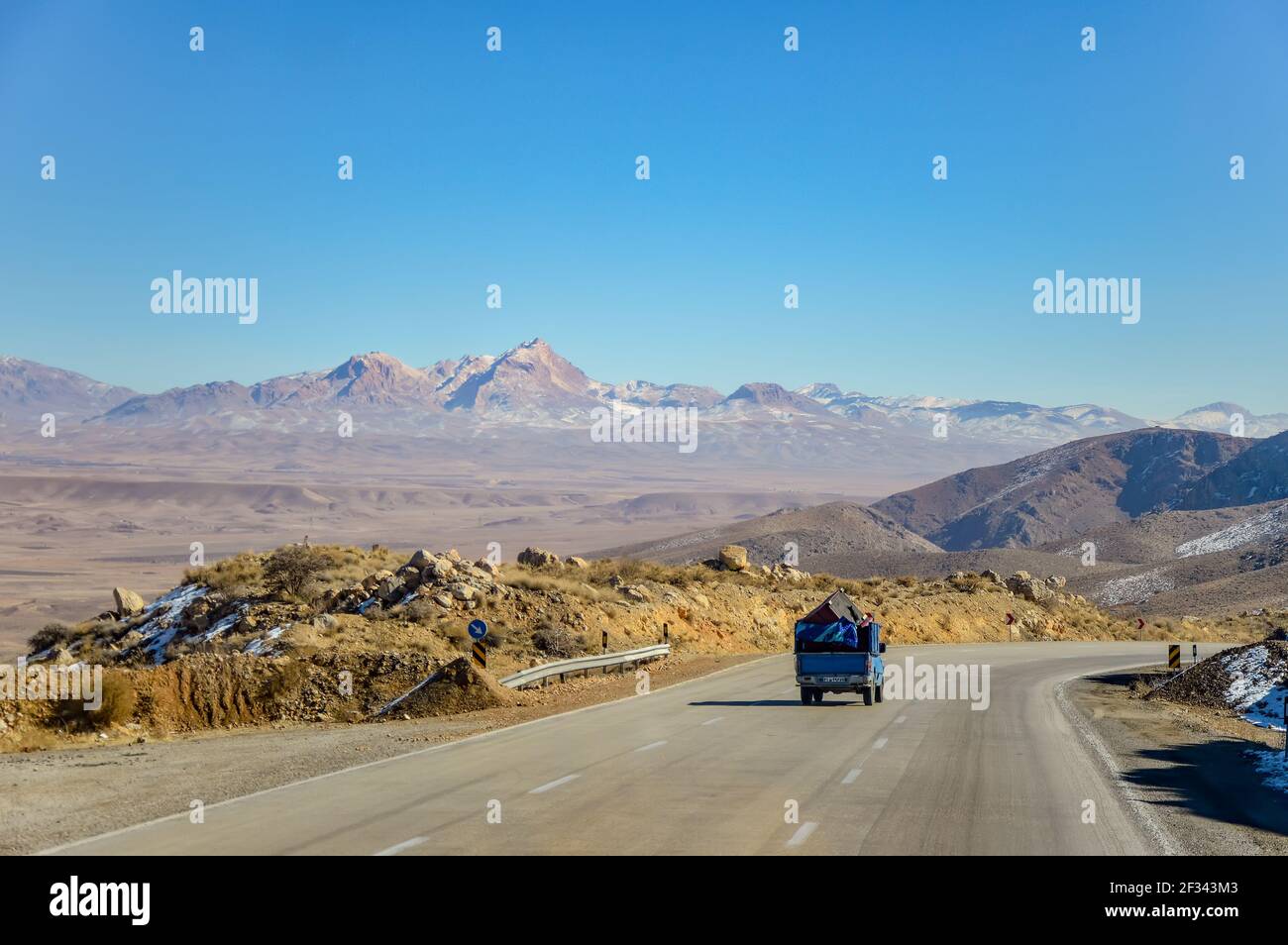 A blue car driving on a scenic road in Iran Stock Photo - Alamy