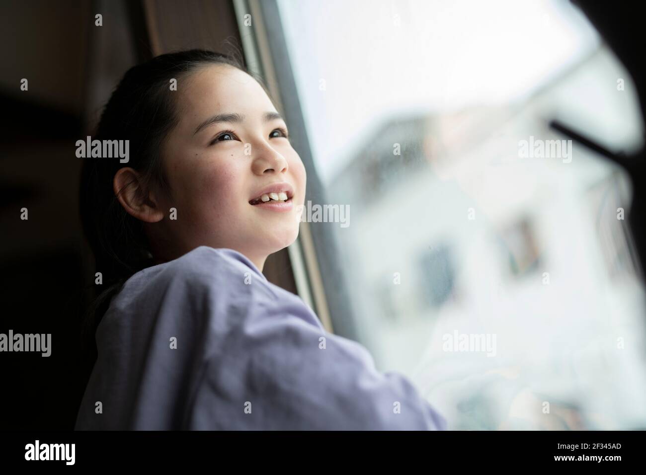 Girl Looking Out Window Stock Photo - Alamy