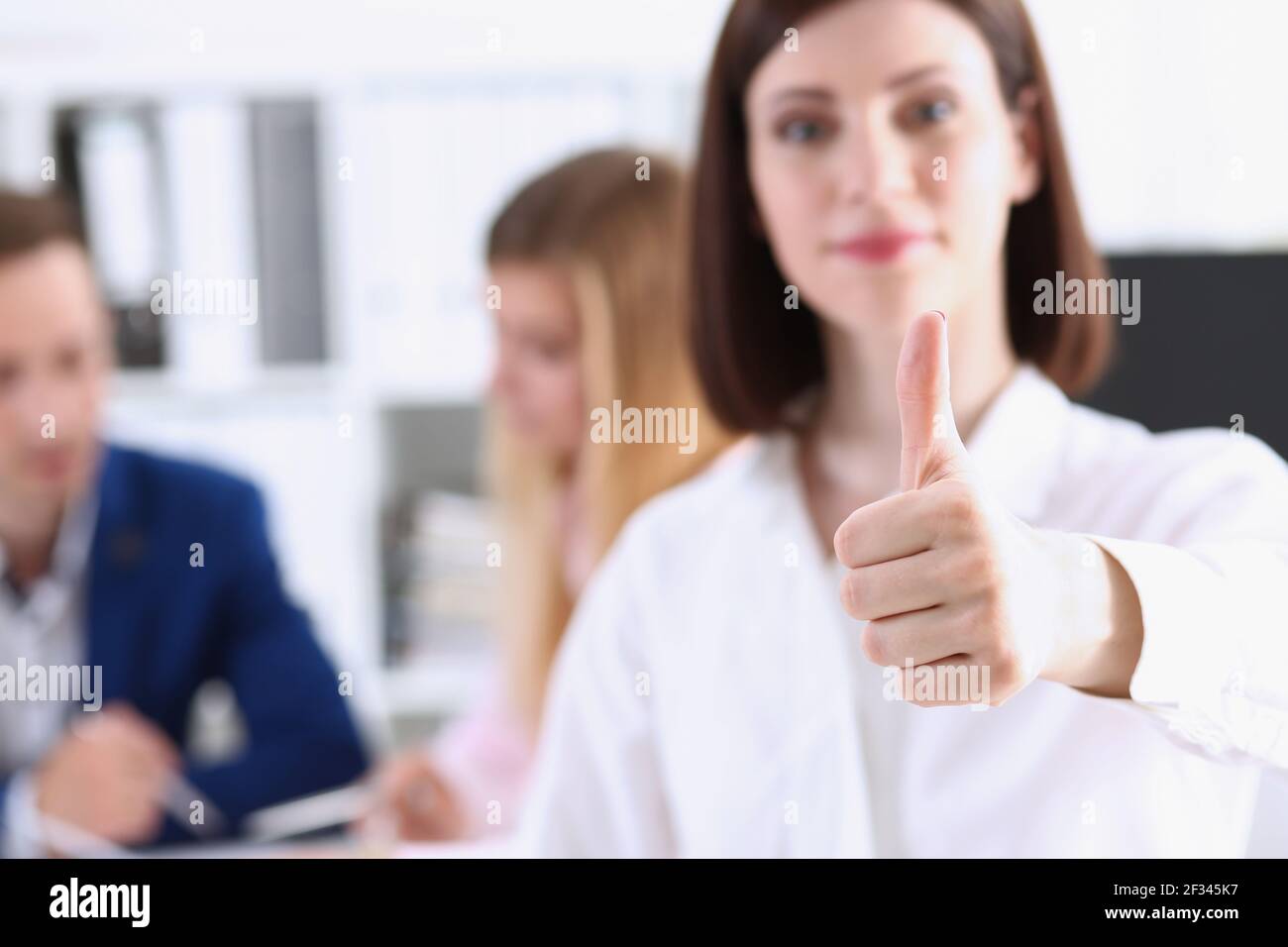 Female arm show OK or approval with thumb up Stock Photo - Alamy