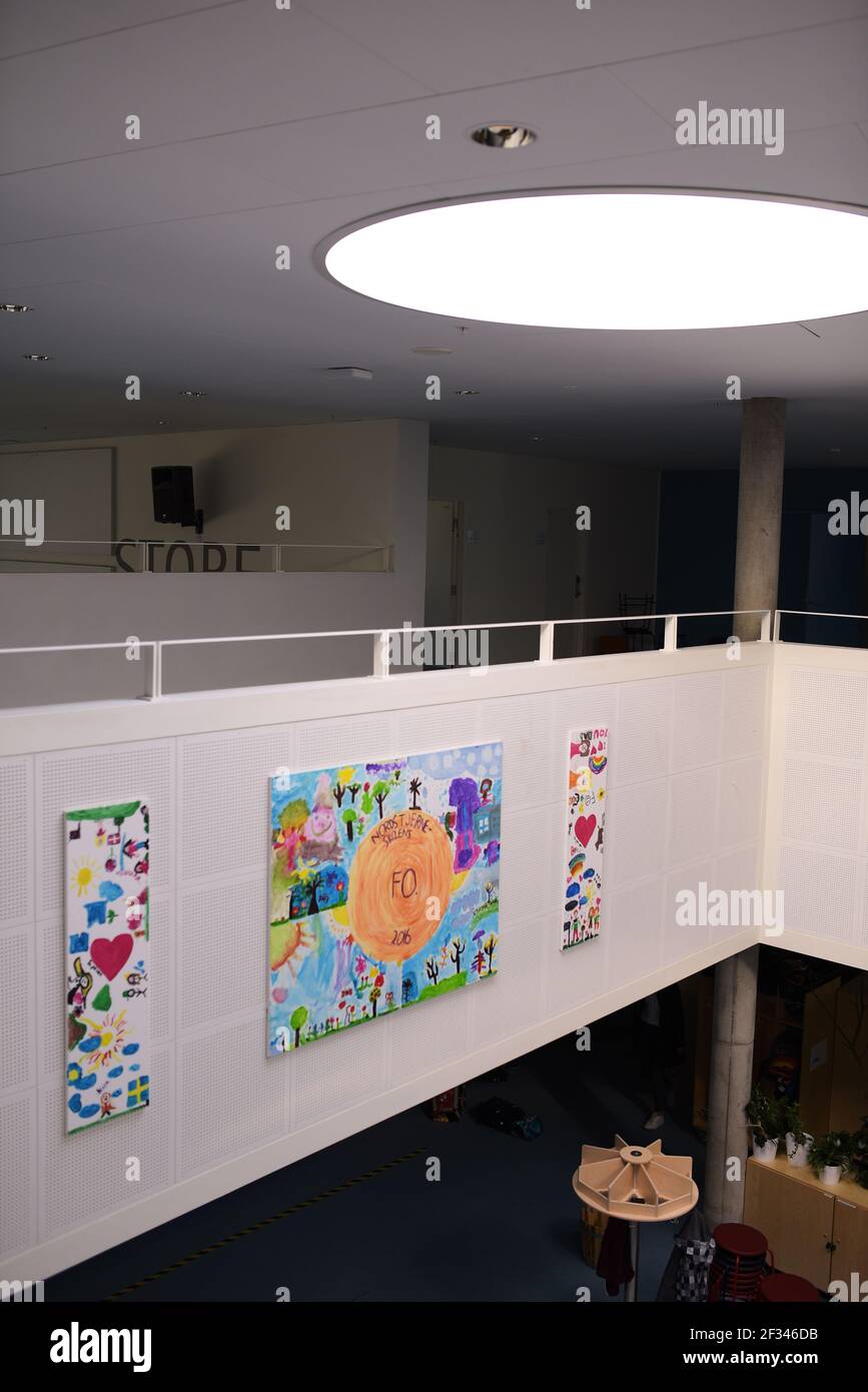 Art and paintings on school walls in empty hallway Stock Photo - Alamy