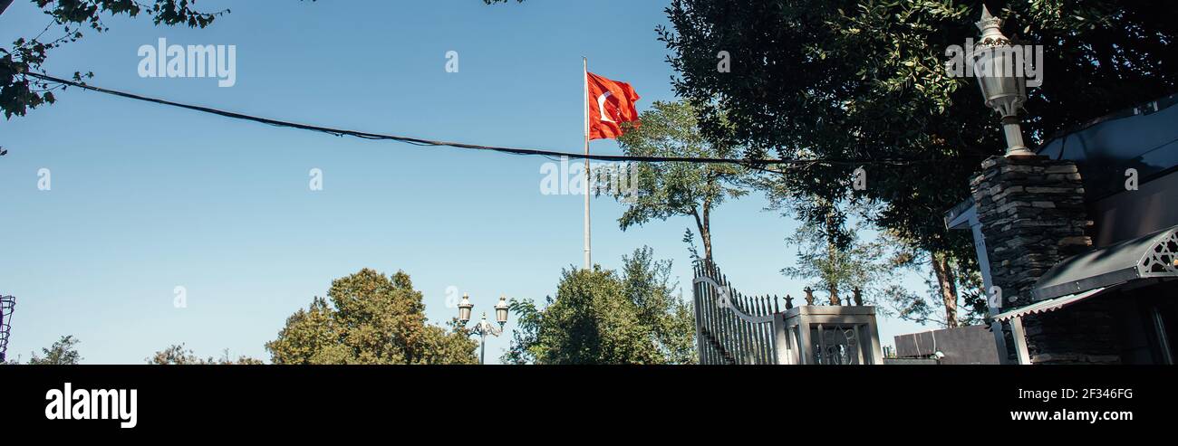 Red trkish flag with blue sky at background on street in Istanbul ...