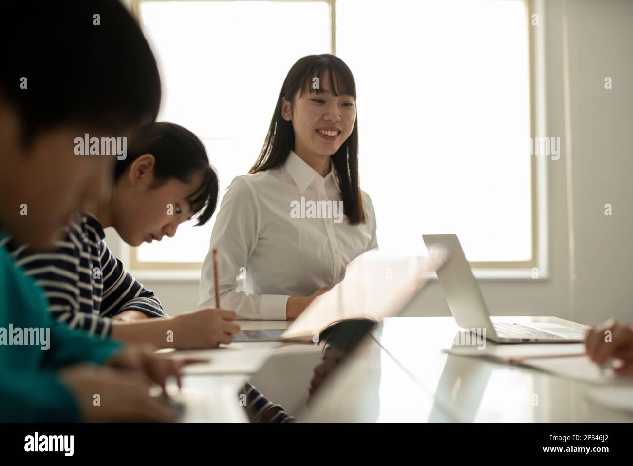 ICT in Education - Female Teacher Facilitating Stock Photo - Alamy