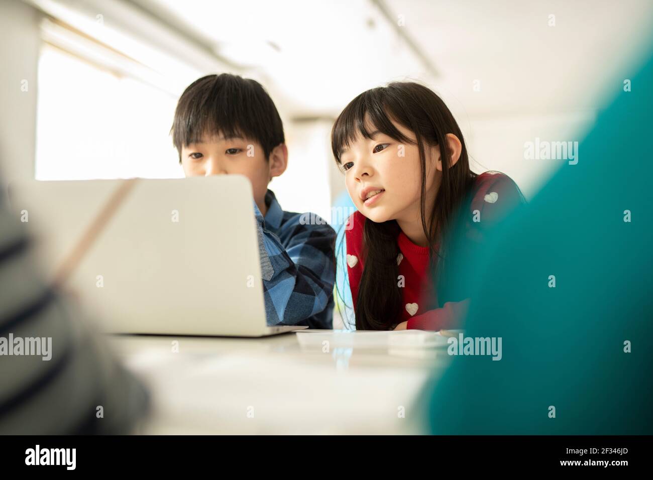 ICT in Education - Boy and Girl Looking at PC Stock Photo - Alamy