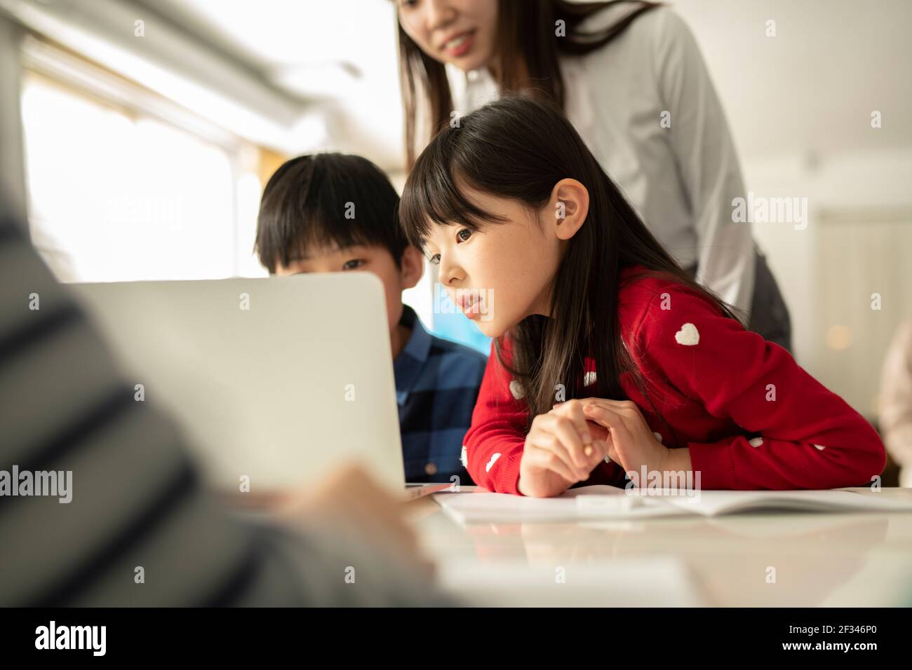 ICT in Education - Elementary School Students and Teacher Looking at PC ...