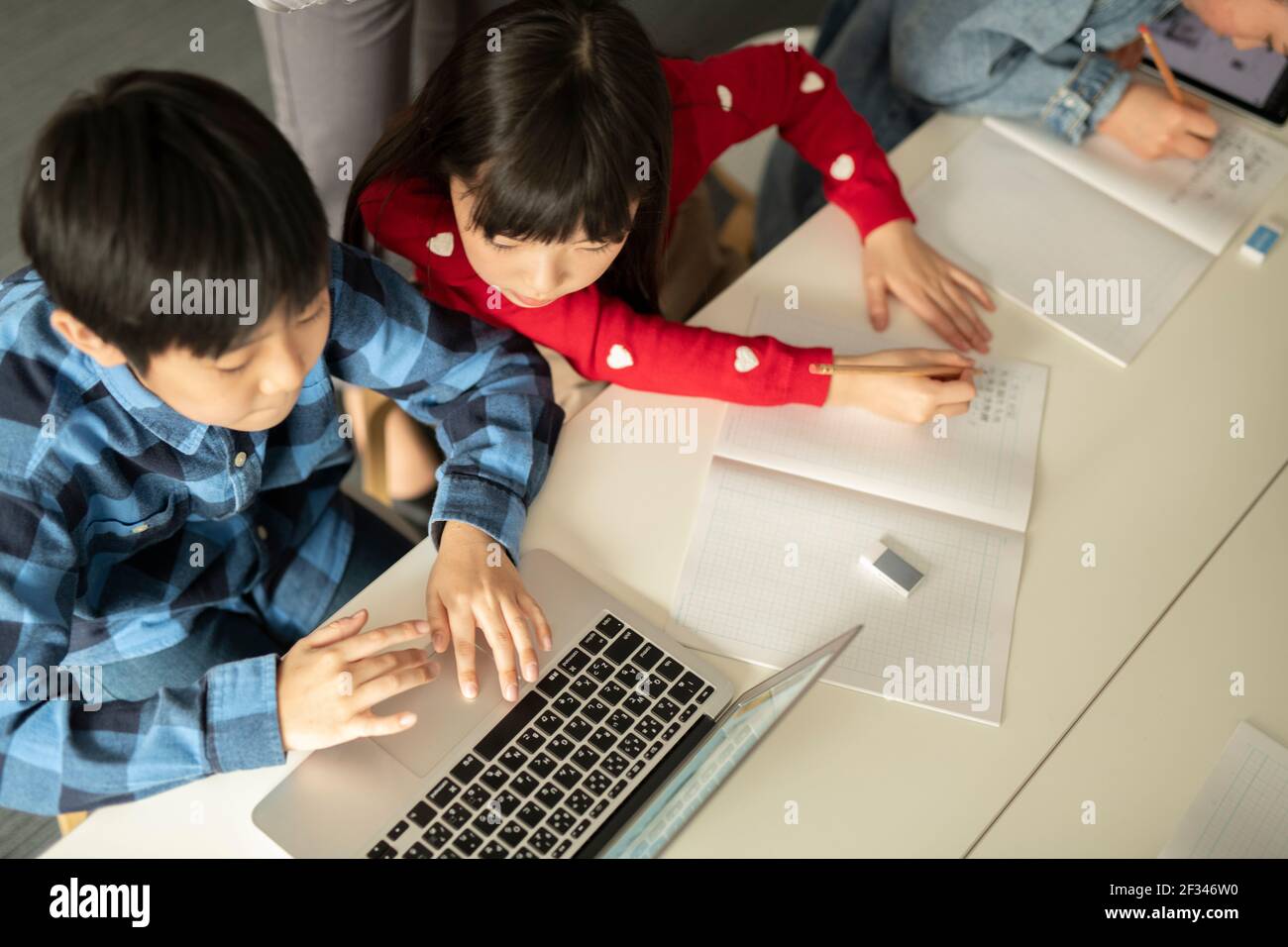 ICT in Education - Boy and Girl Looking at PC Stock Photo - Alamy