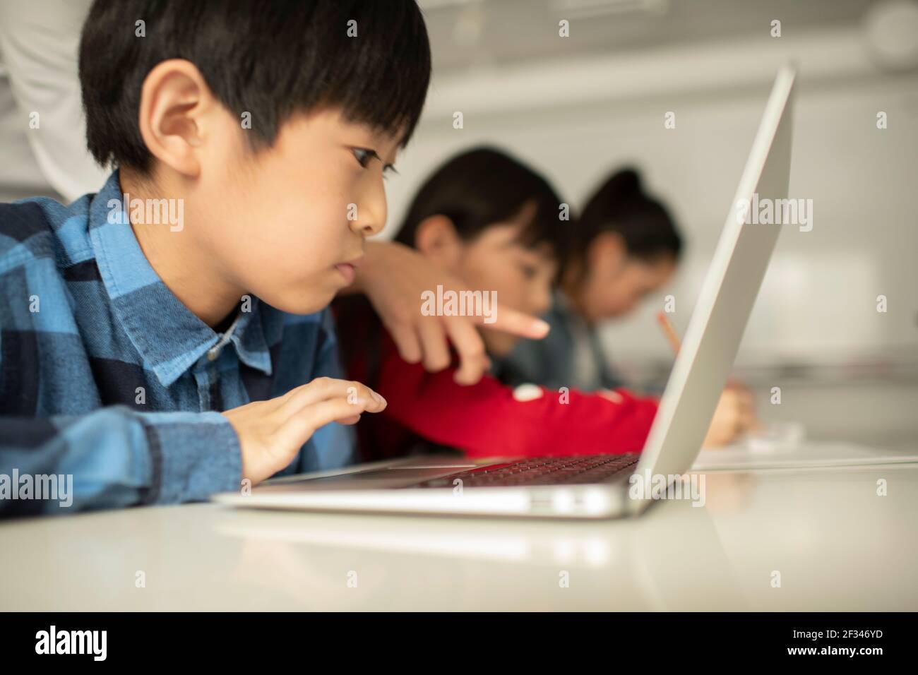 ICT in Education - Boy and Girl Looking at PC Stock Photo - Alamy
