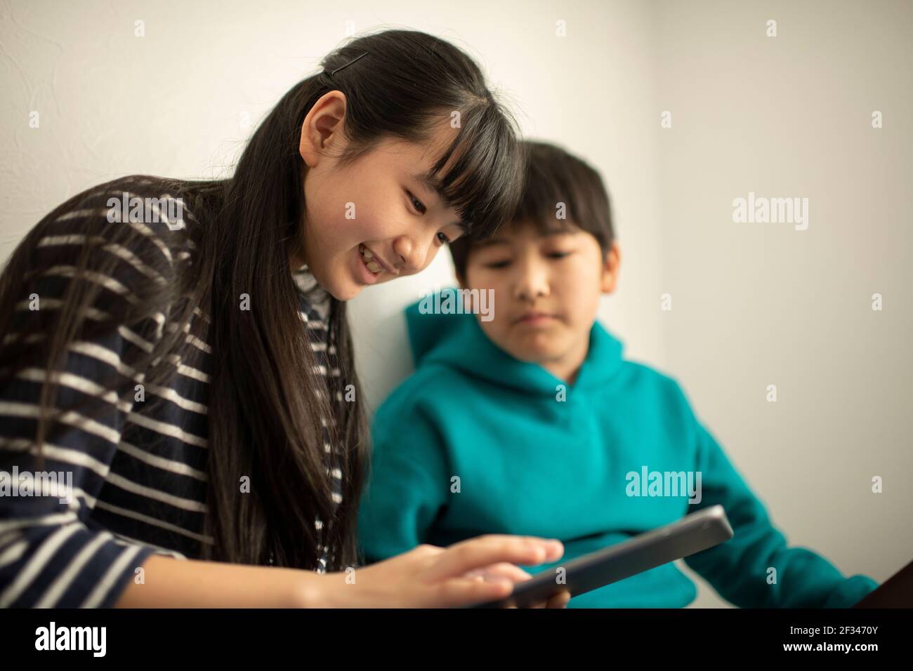 ICT in Education - Boy and Girl Utilizing Digital Devices Stock Photo ...