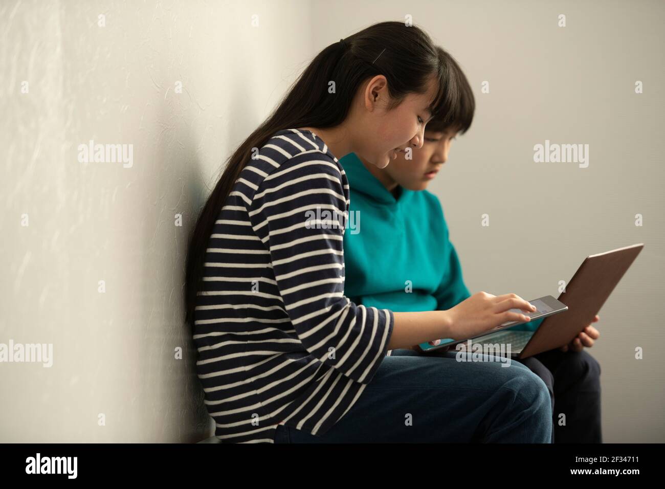ICT in Education - Boy and Girl Utilizing Digital Devices Stock Photo ...