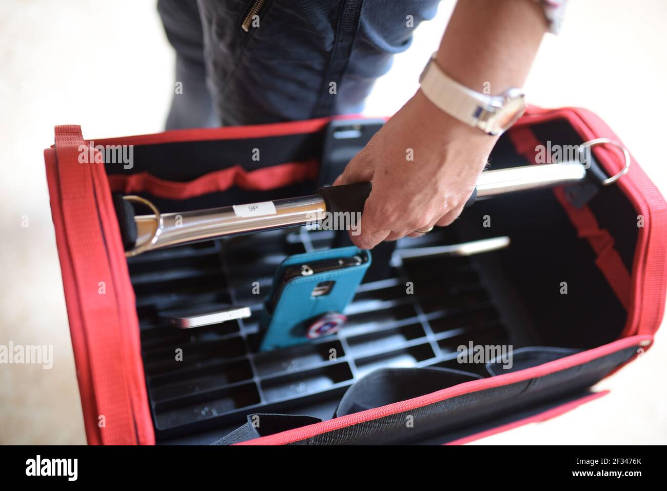man holding a red tool box to work on repair Stock Photo - Alamy