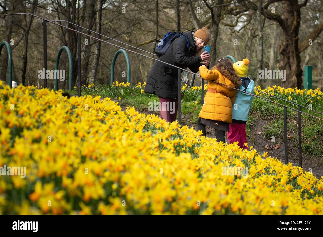 Cardiff, Wales, UK. 13th March 2021. Pictured: A young mother shows ...