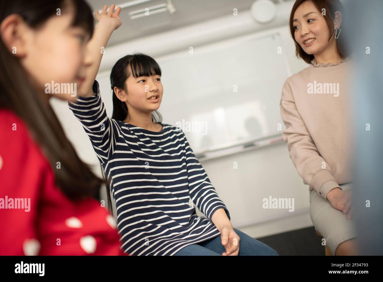 Group Discussion - Girl Raising Hand Stock Photo - Alamy