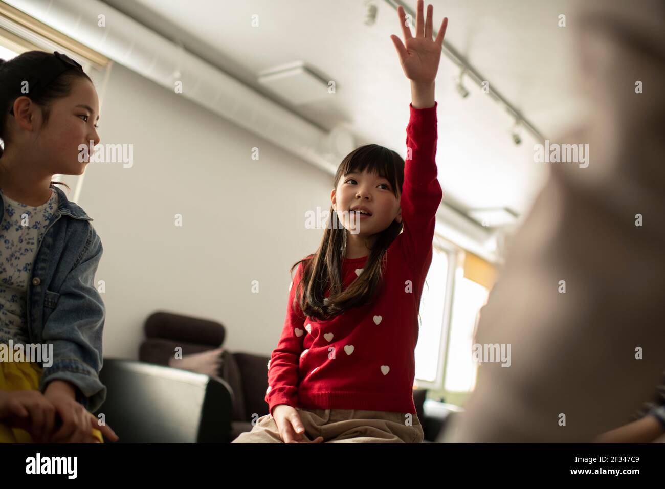 Group Discussion - Girl Raising Hand Stock Photo - Alamy