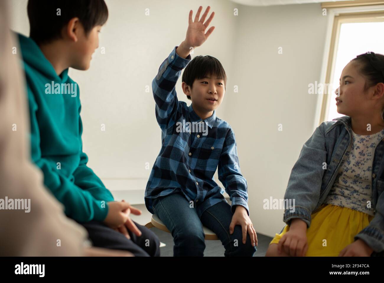 Group Discussion - Boy Raising Hand Stock Photo - Alamy
