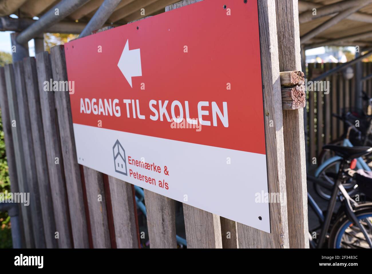 large red sign showing the entrance to school Stock Photo - Alamy