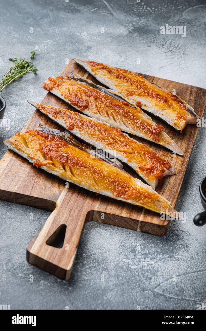 Marinated mackerel fillet with garlic and saffron on grey background ...