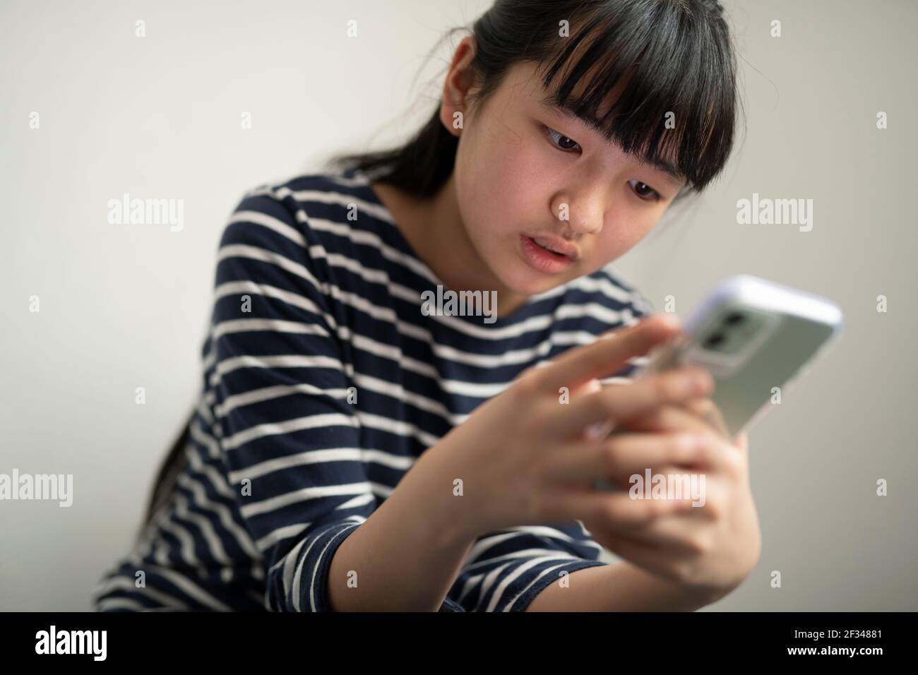 Girl Obsessed with Smartphone Stock Photo - Alamy