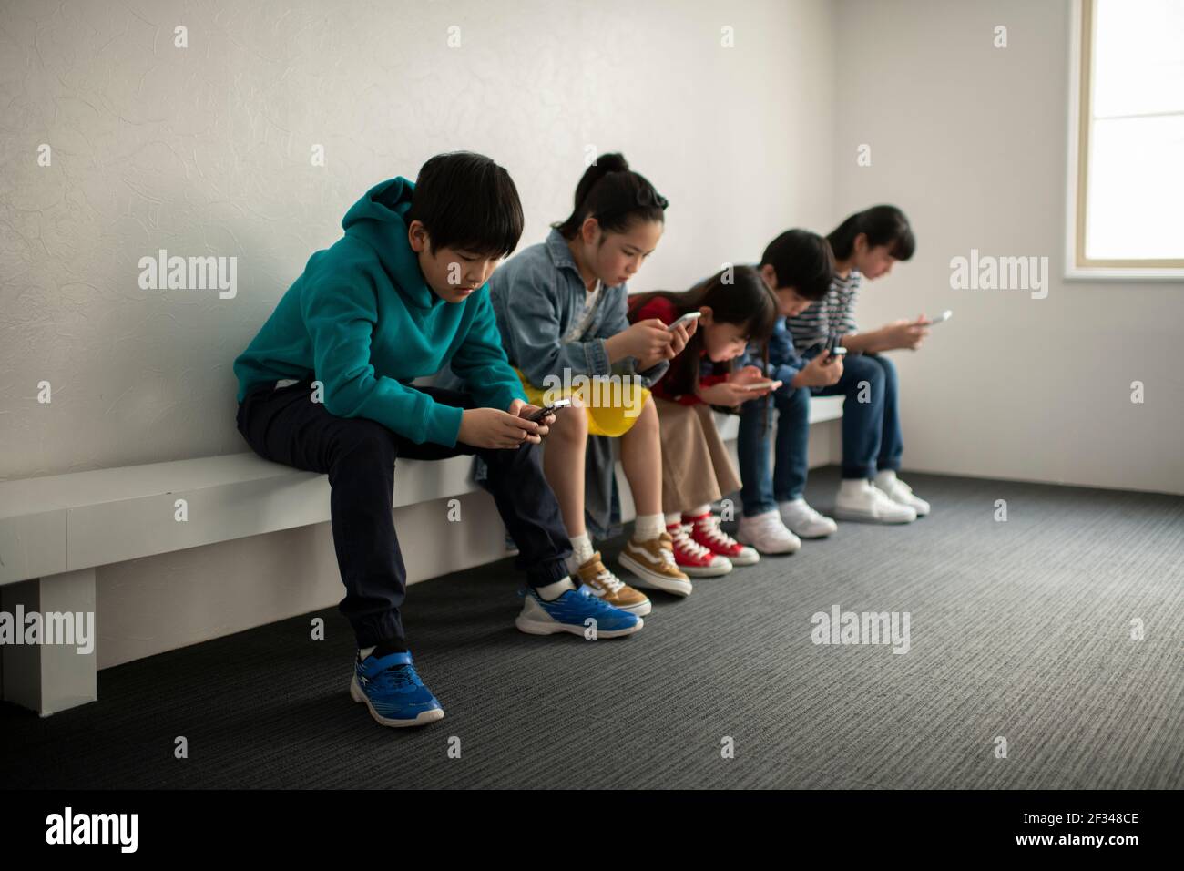 Child cell phone obsessed hi-res stock photography and images - Alamy