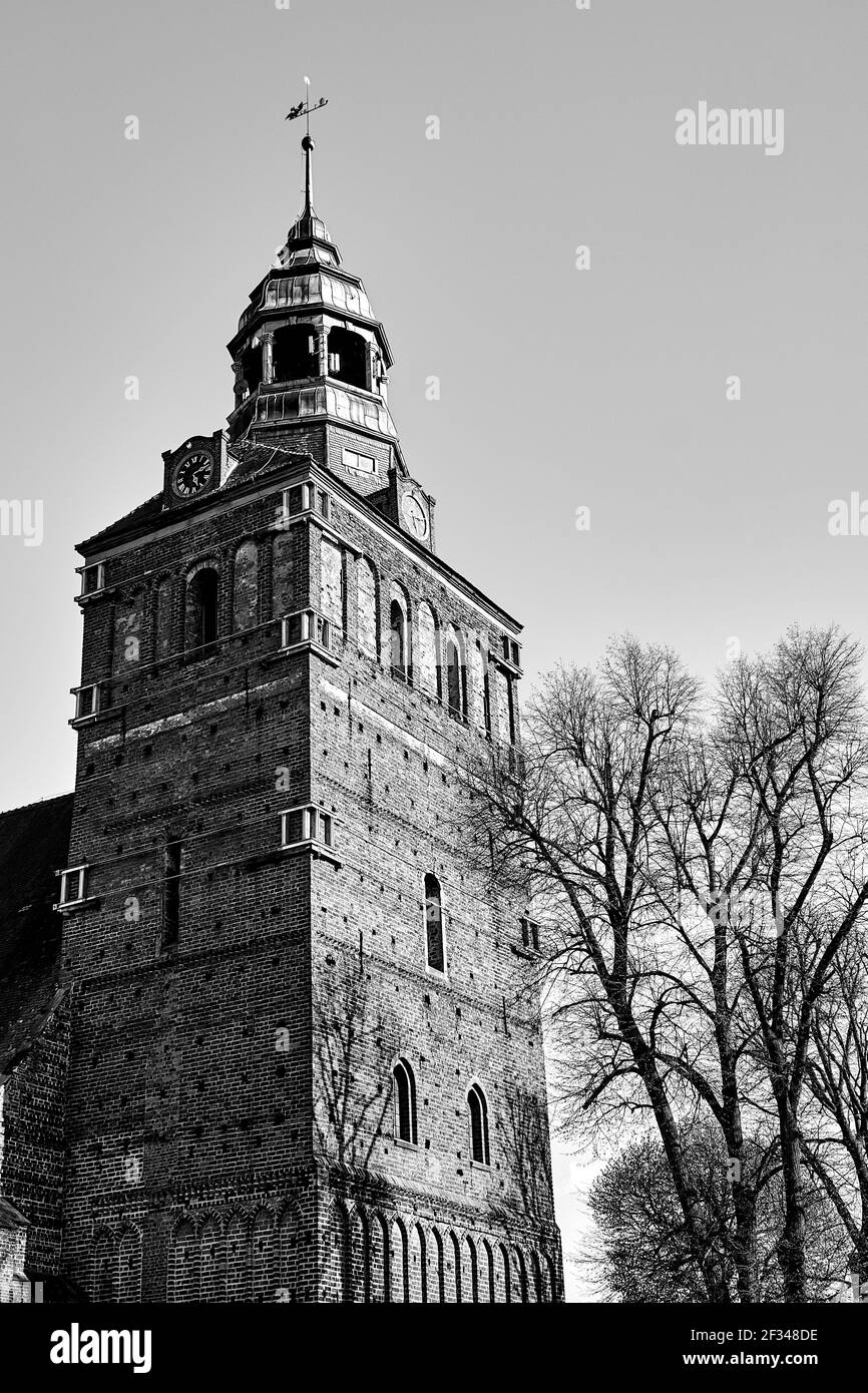 Belfry of the Gothic church in Osno in Poland, monochrome Stock Photo ...