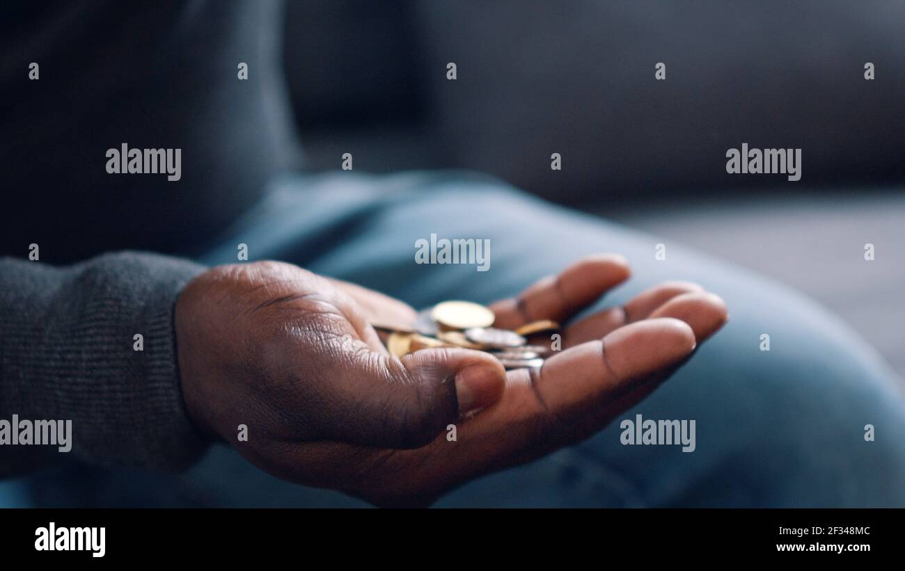 Close up hands with coins. African american black man holding coins ...