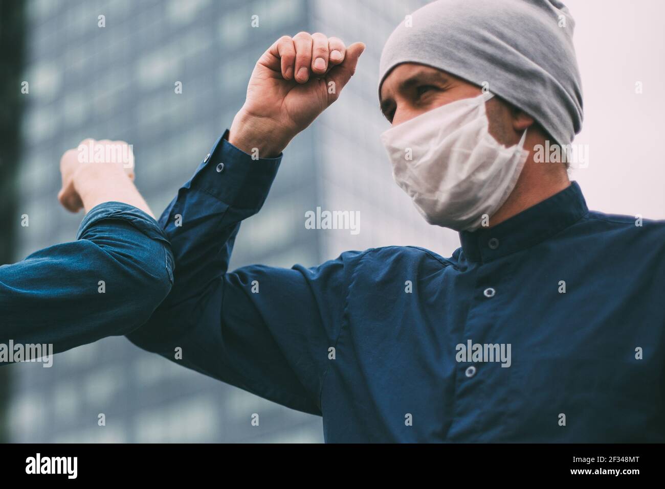close up. two young men greeting each other with their elbows Stock ...