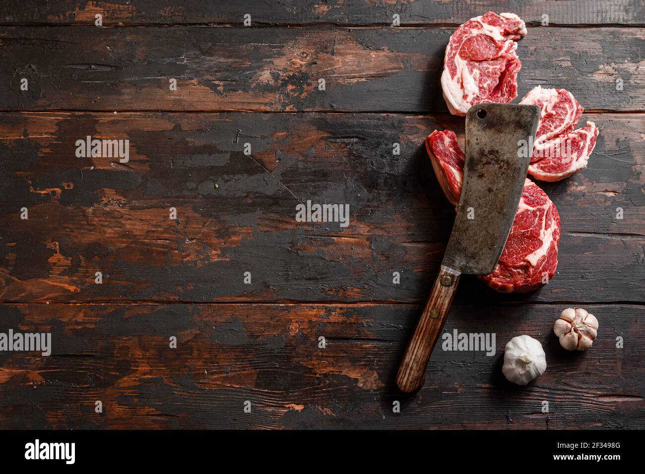 Raw Chuck eye roll steak, Scotch Fillet, Beef Rib Steak, meat cleaver ...