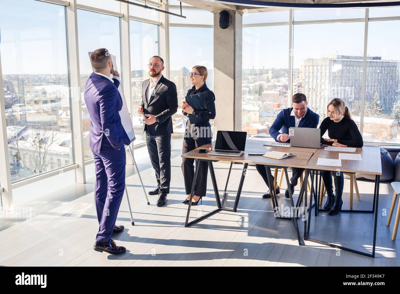 Confident businessman makes a presentation of a new project in the ...