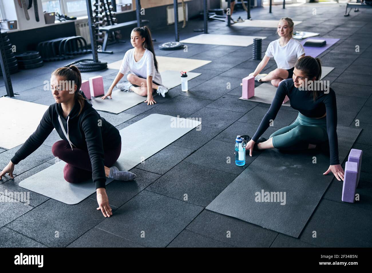 Four best friends doing yoga together at the gym Stock Photo - Alamy