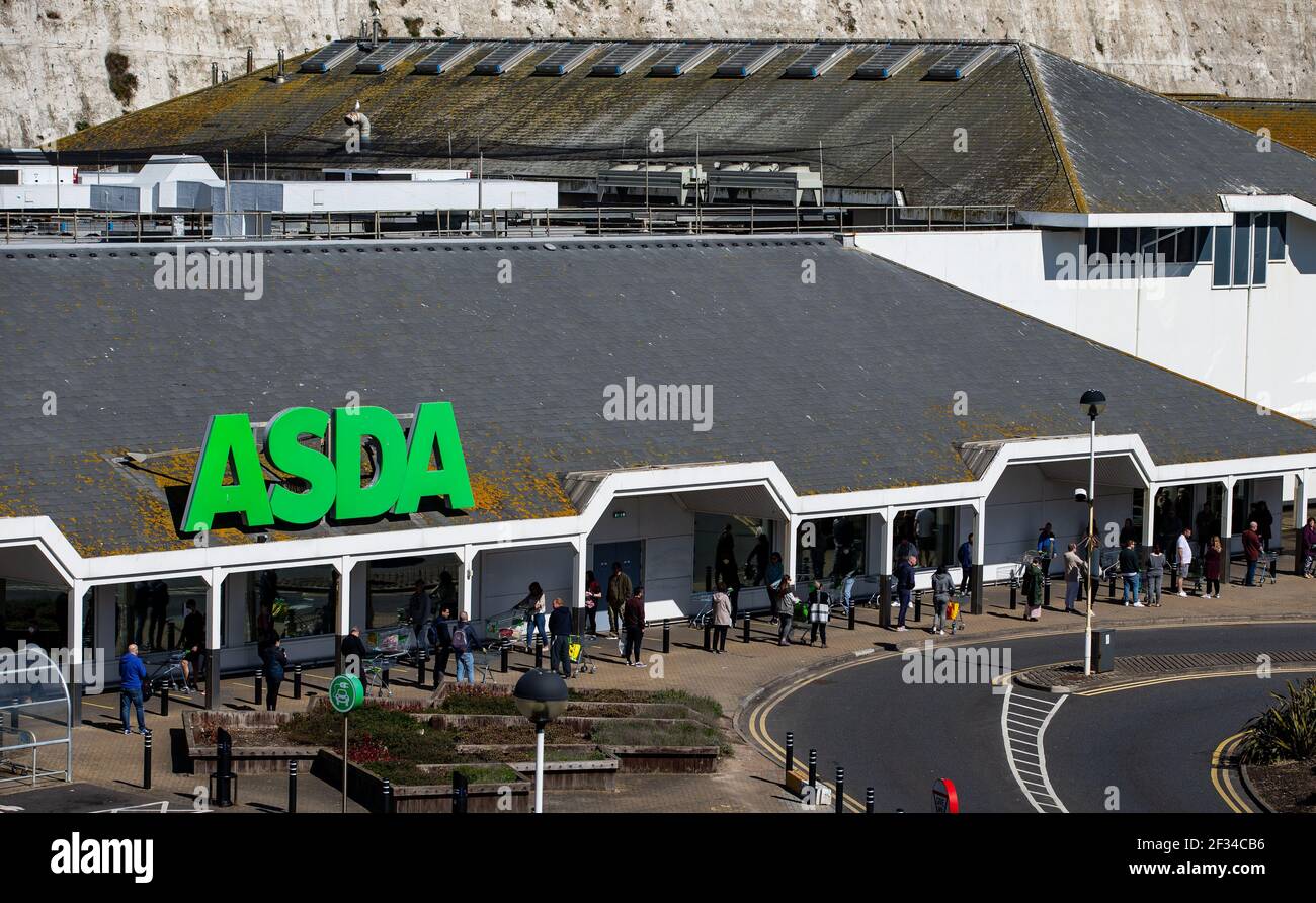 General view of people waiting 2 meters apart queuing up outside Asda ...