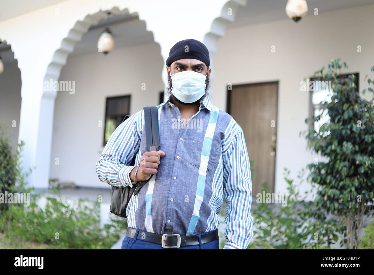 A middle-aged Indian man with a turban, wearing a mask - new normal ...