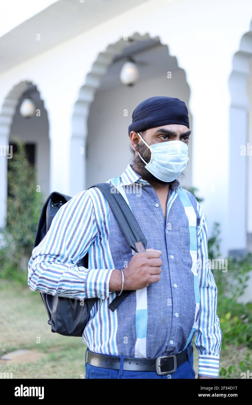 A middle-aged Indian man with a turban, wearing a mask - new normal ...