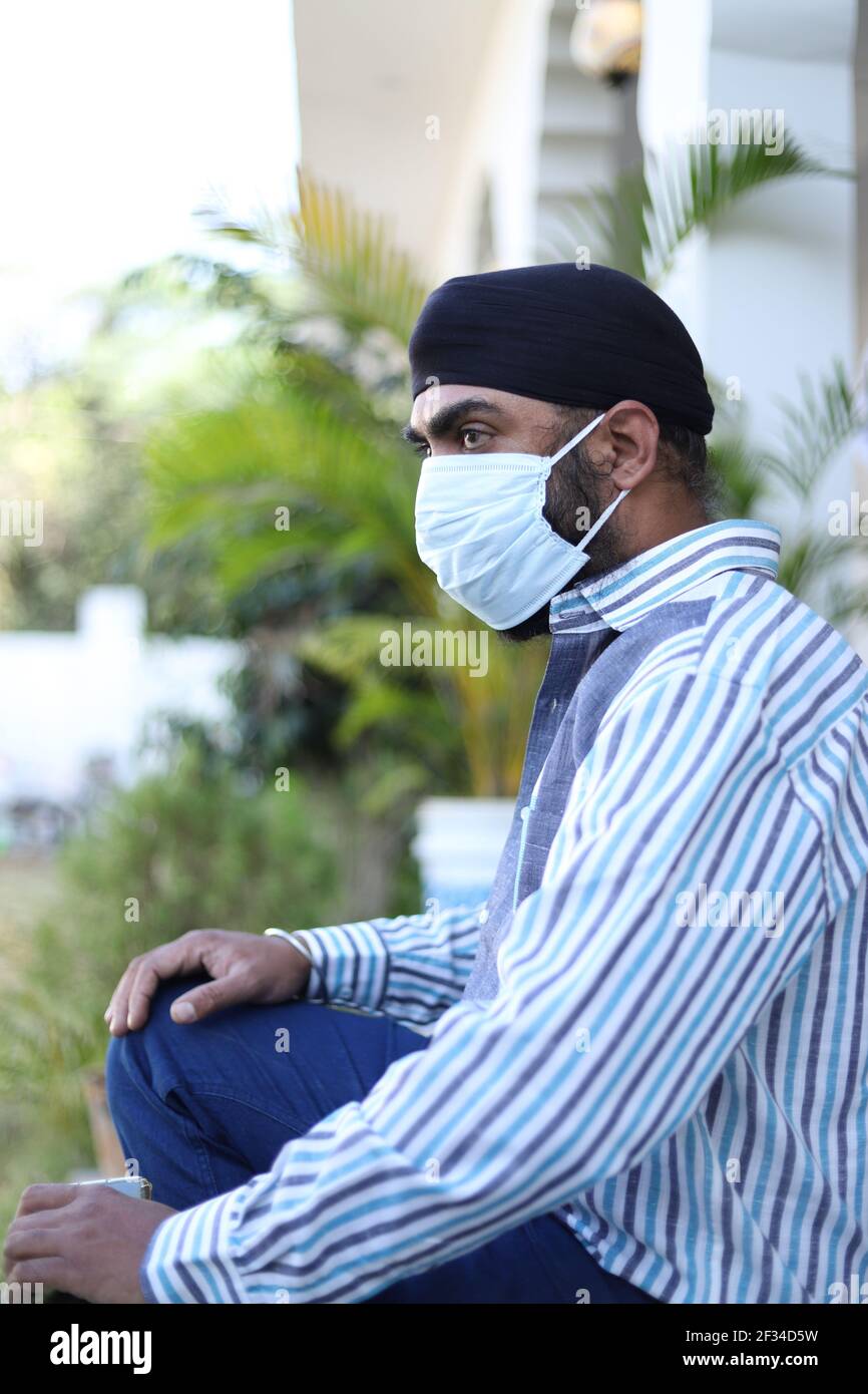 A middle-aged Indian man with a turban, wearing a mask - new normal ...
