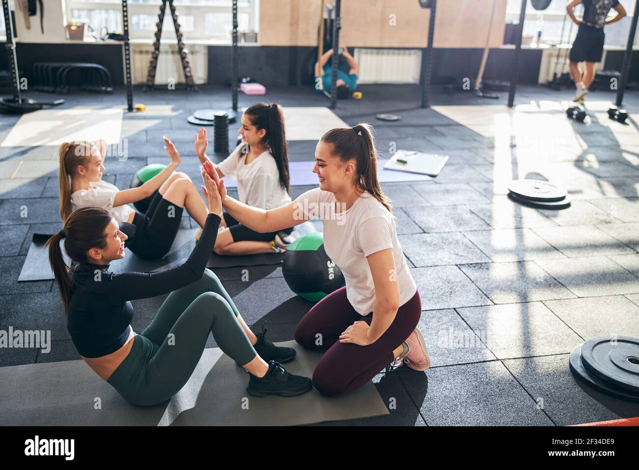 Positive ladies doing abs workout at the gym Stock Photo - Alamy
