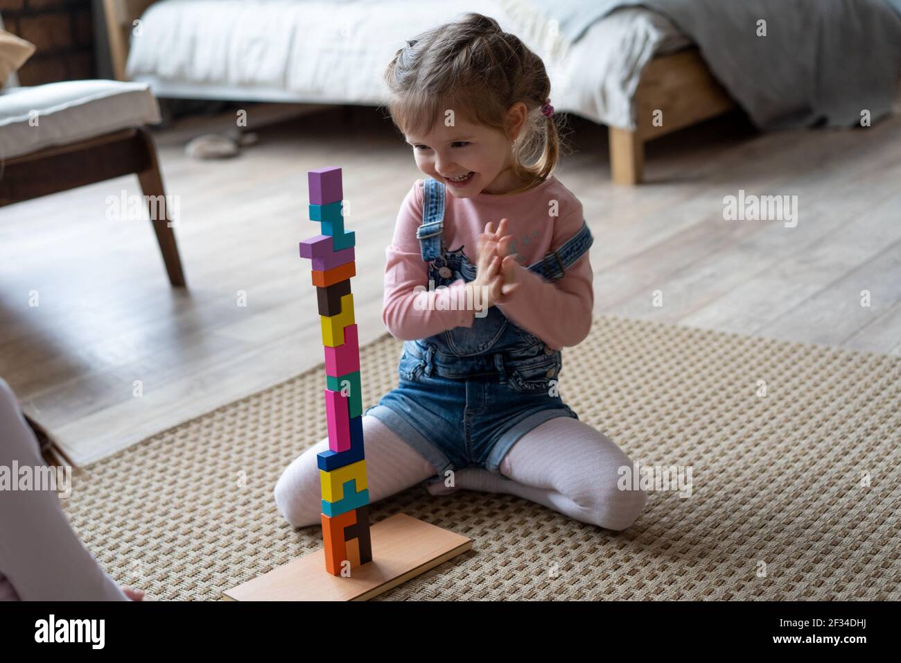 Kids playing with wooden blocks laying on the floor in their room Stock ...