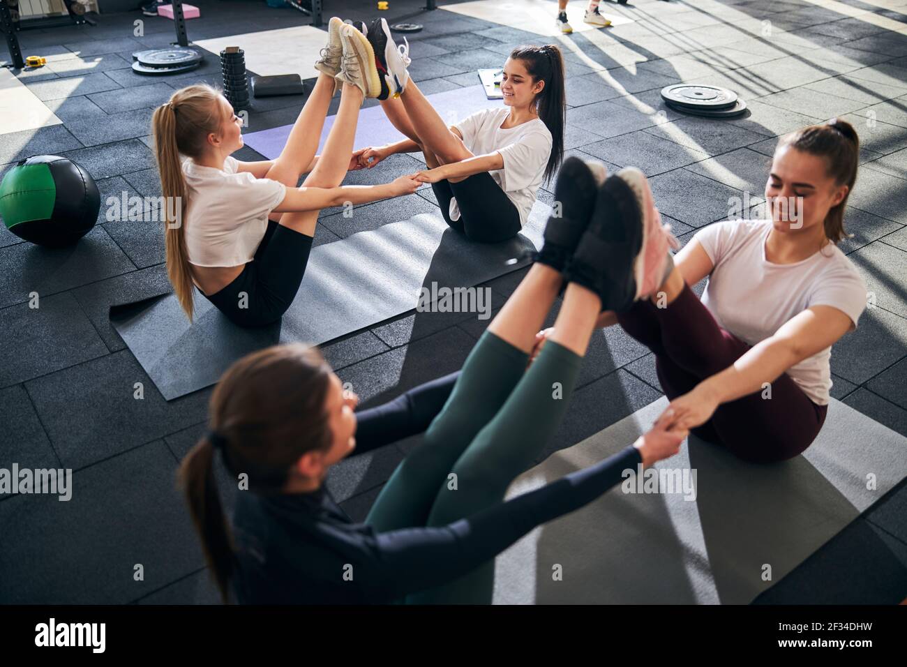 Fit ladies practising balance exercises while working in pairs Stock ...