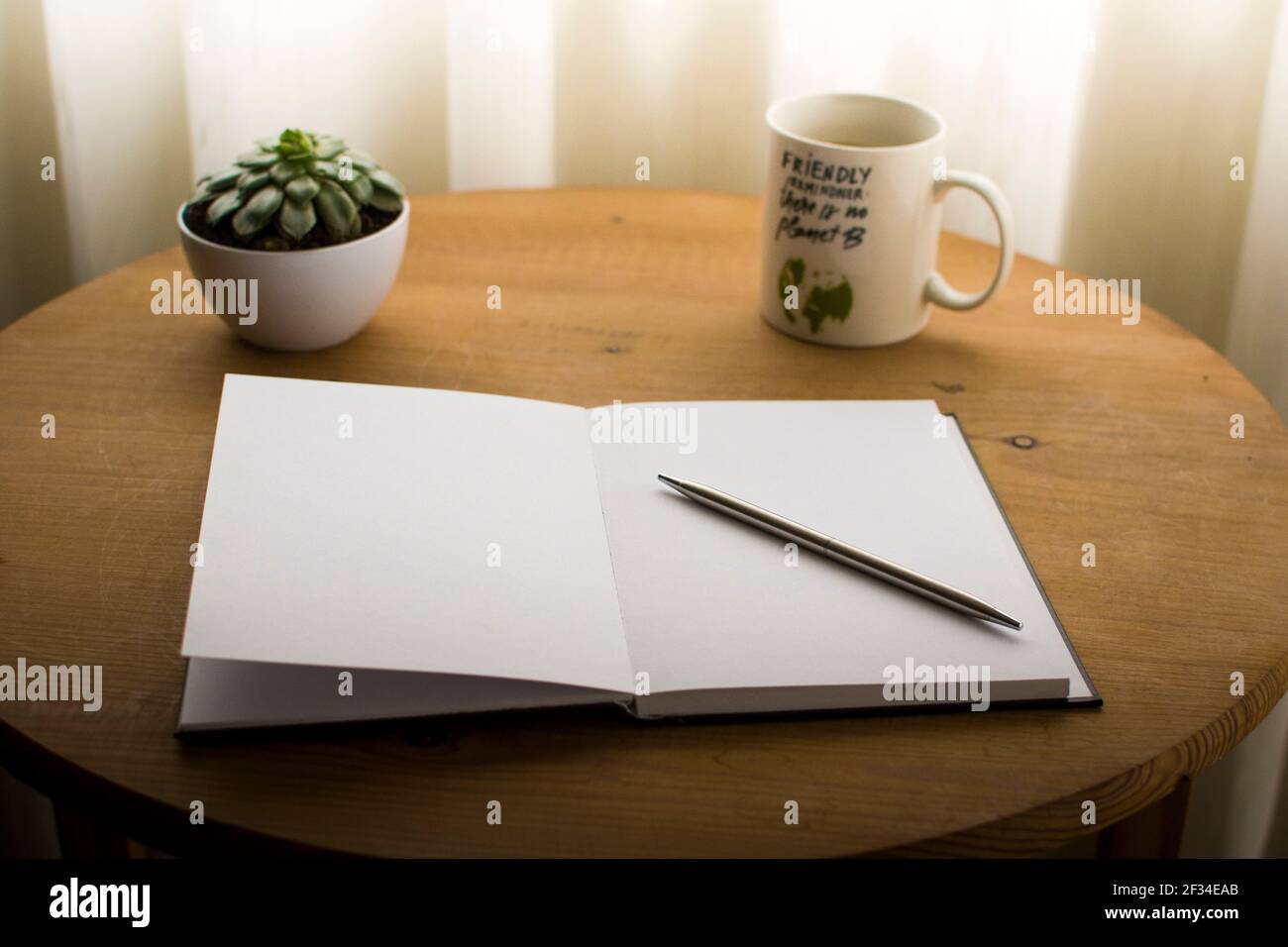 Minimalist work space at home, with cup of coffee and open blank ...