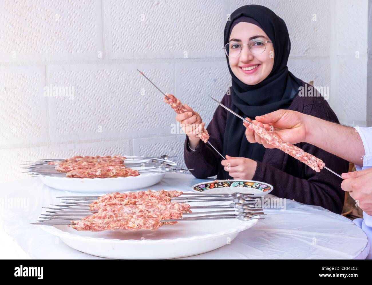 Arabic Muslim family preparing for barbeque Stock Photo - Alamy