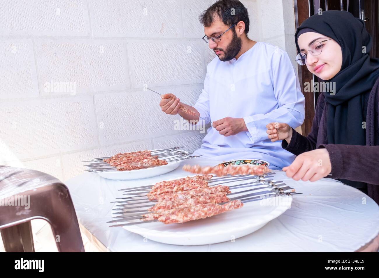 Arabic Muslim family preparing for barbeque Stock Photo - Alamy