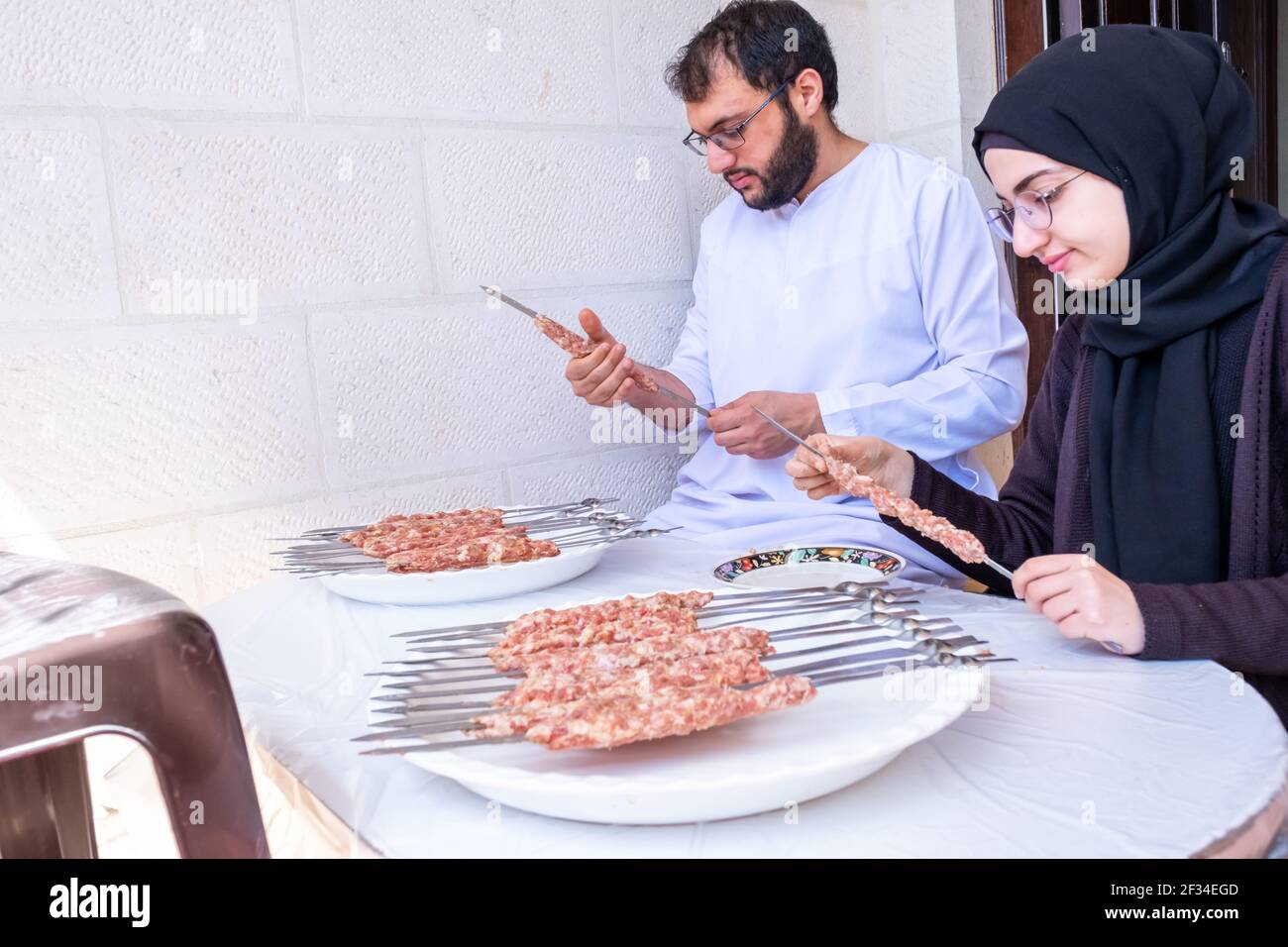 Arabic Muslim family preparing for barbeque Stock Photo - Alamy