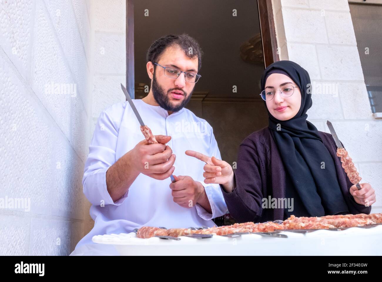 Arabic Muslim family preparing for barbeque Stock Photo - Alamy