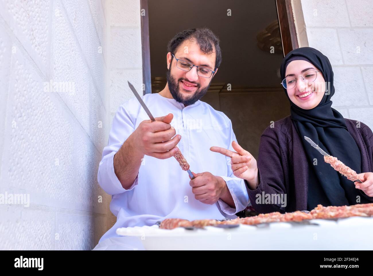 Arabic Muslim family preparing for barbeque Stock Photo - Alamy